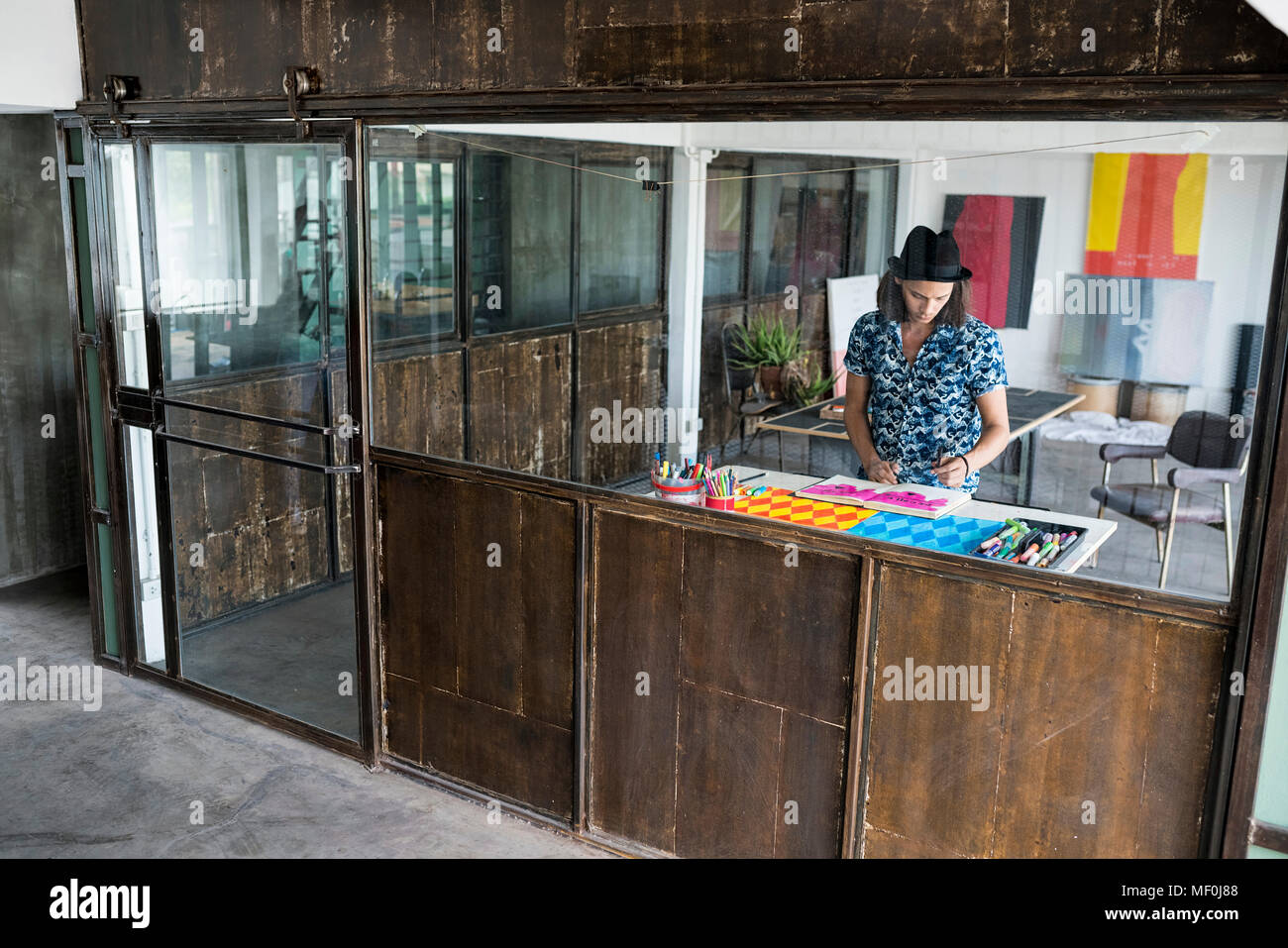 Artist at work, drawing in a notebook in his loft studio Stock Photo ...