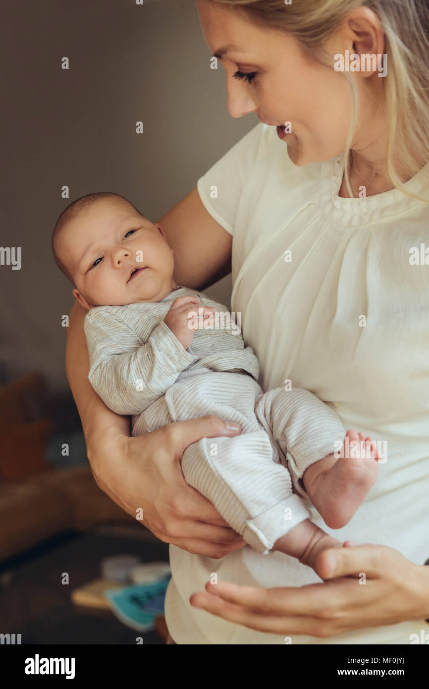 Newborn baby being held in mother‚Äôs arms Stock Photo - Alamy