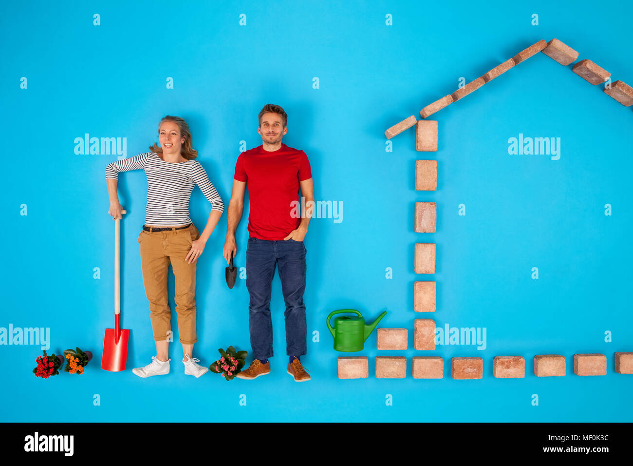 Happy home owners are standing proudly in their garden Stock Photo - Alamy
