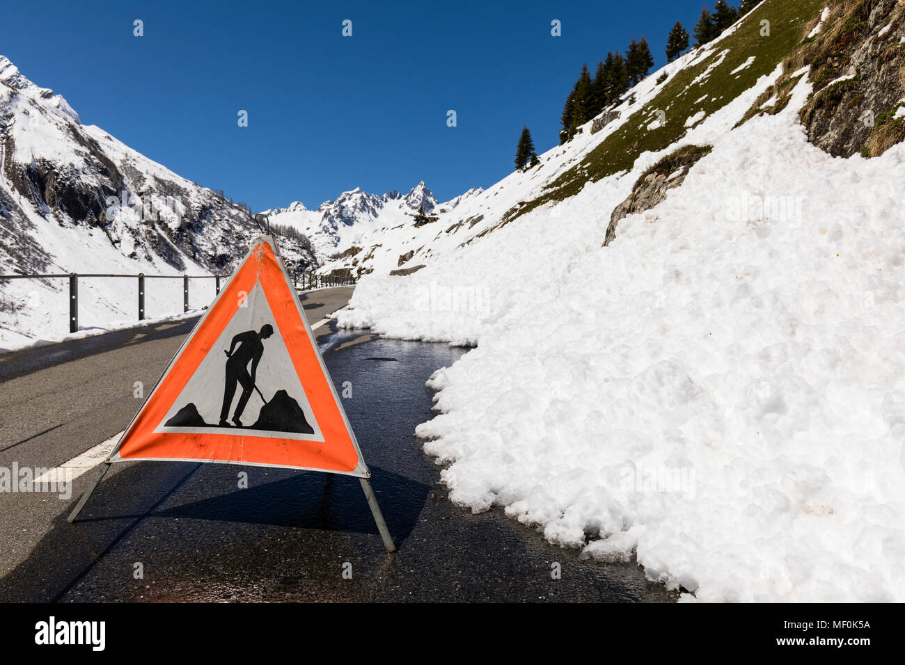 Warning sign because of a road blocked by a snow slide in the Alps ...