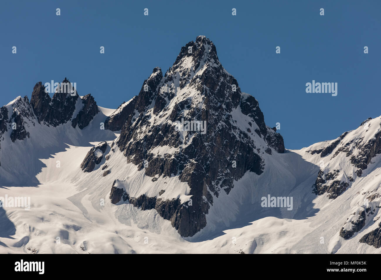Snow-covered, fresh white mountain peak in the Alps of Switzerland ...