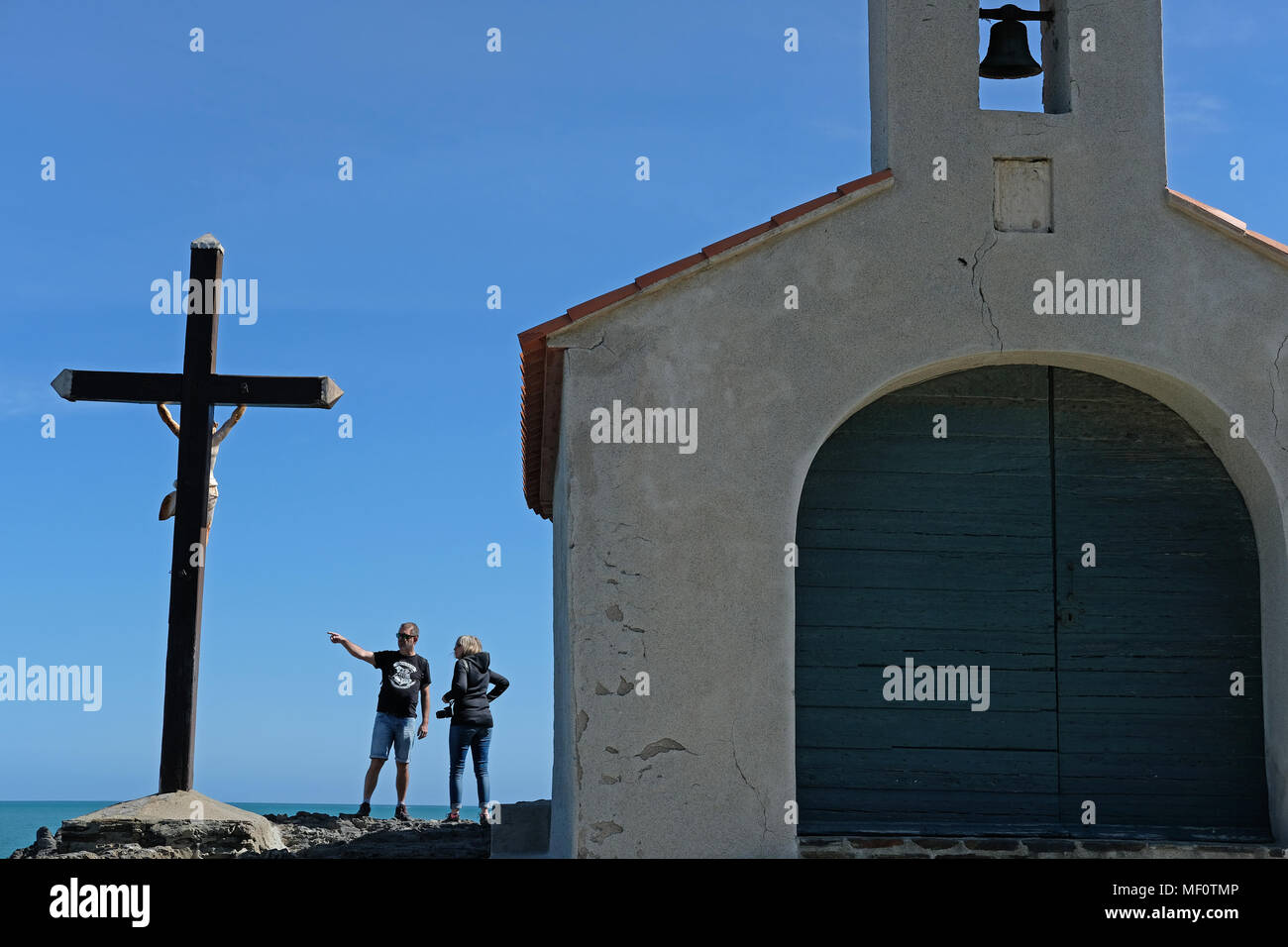 People looking at Christ on the cross in Collioure,France Stock Photo ...