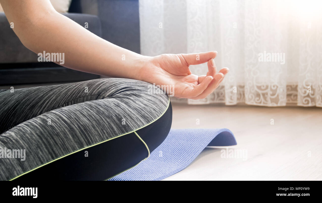 Closeup photo of female hand meditating on floor at home Stock Photo ...