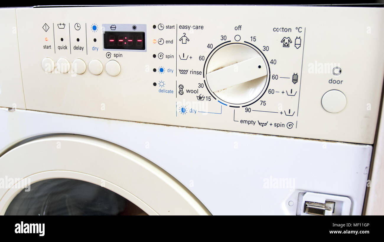 Closeup photo of buttons and knobs on washing machine control panel ...