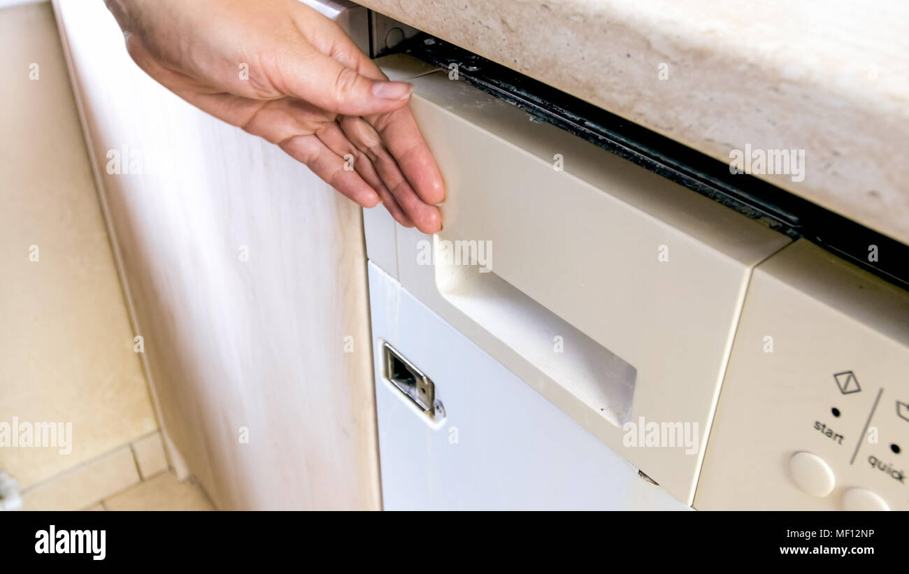 Closeup photo of female hand closing box for liquid washing powder and ...