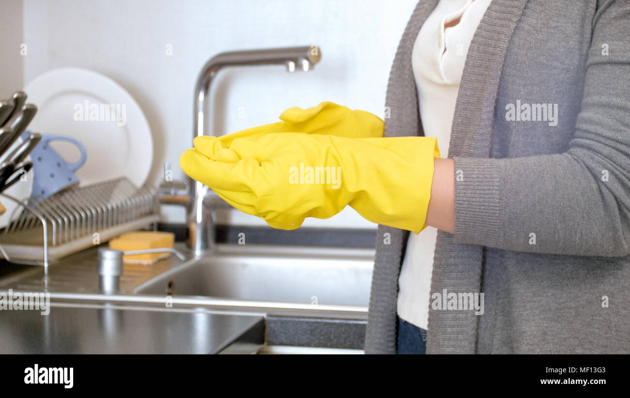 Woman taking off rubber gloves hi-res stock photography and images - Alamy