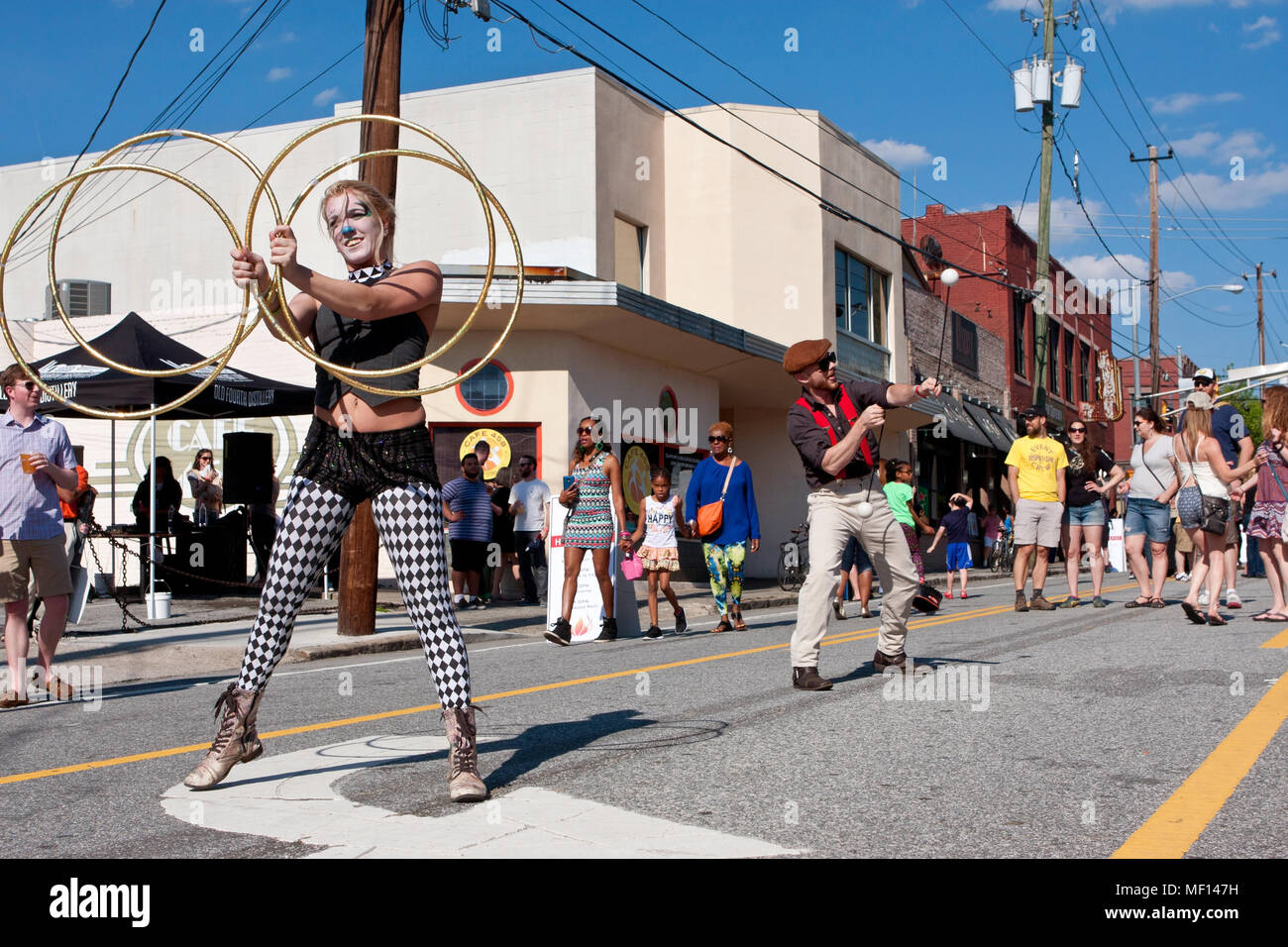 Street performers with the Imperial OPA Circus entertain people walking ...
