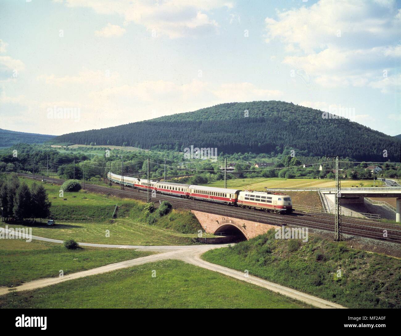 An intercity train of the German Federal Railways drives through a ...