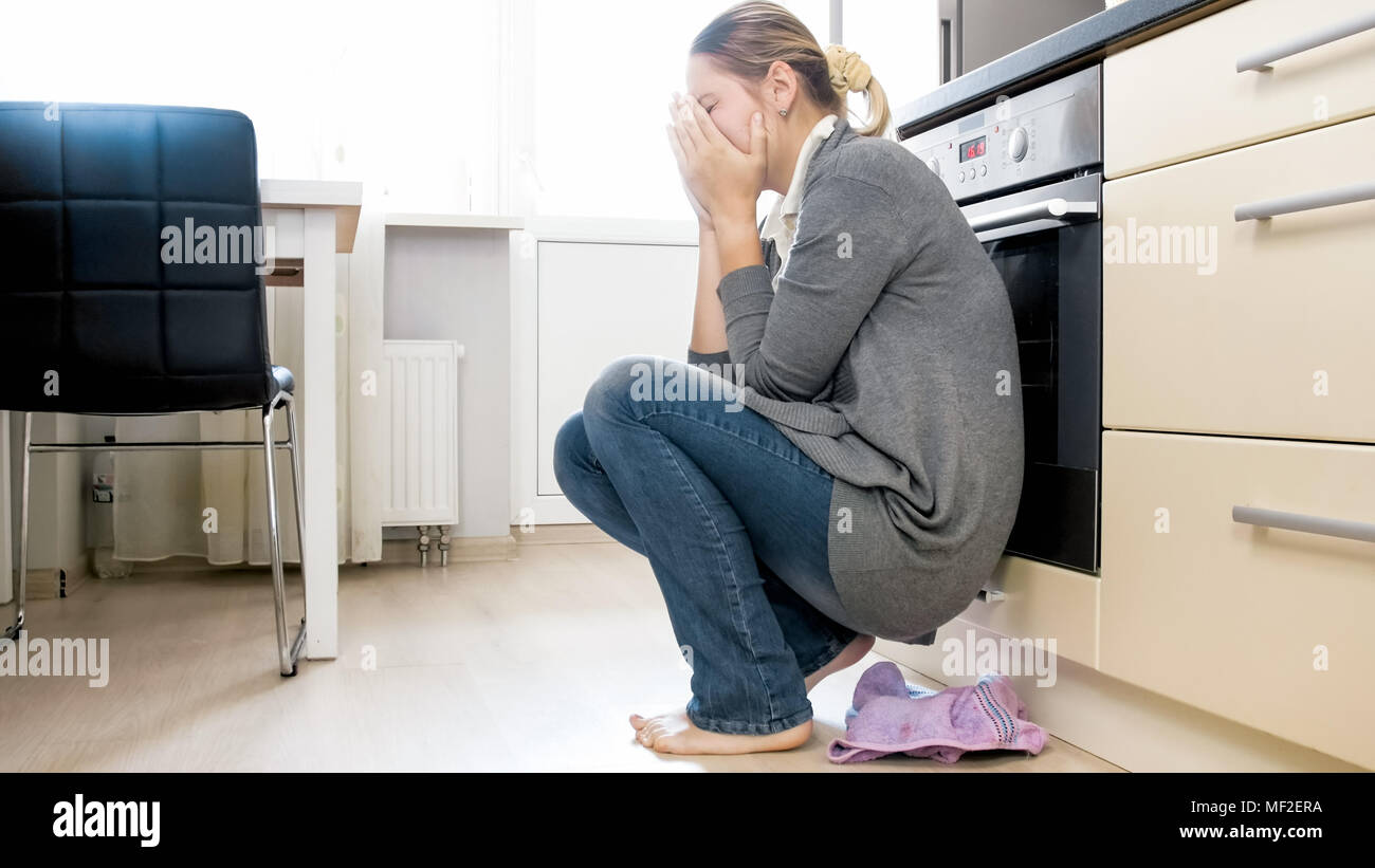 Young woman crying on kitchen hi-res stock photography and images - Alamy