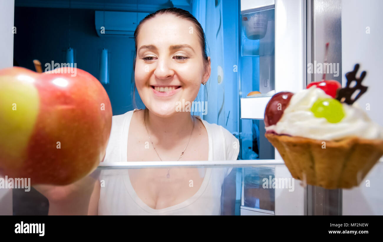 Woman eat apple night fridge refrigerator hi-res stock photography and ...