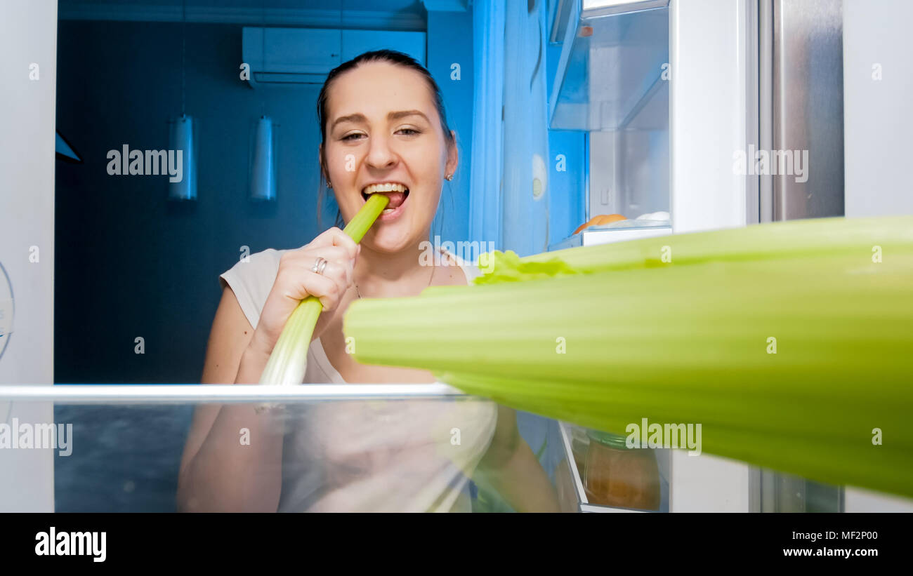 Portrait of happy young woman having late lunch with celery Stock Photo ...