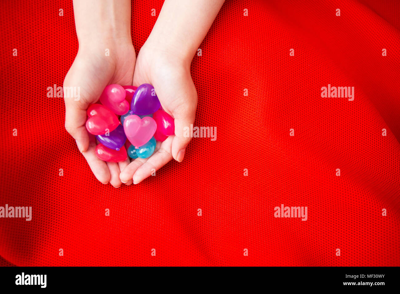 colorful hearts held on hands Stock Photo - Alamy