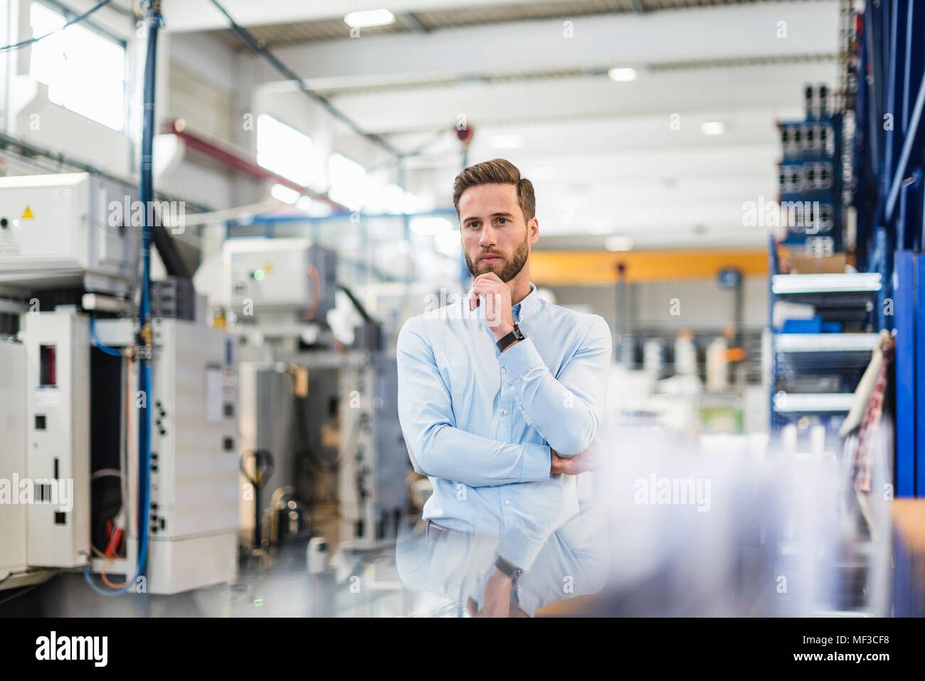 Young businessman in factory Stock Photo - Alamy