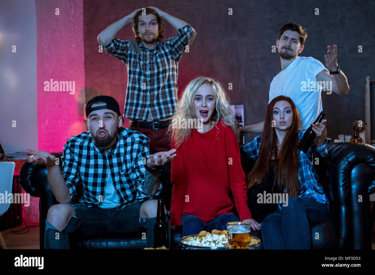 Group of friends watching TV match at home Stock Photo - Alamy