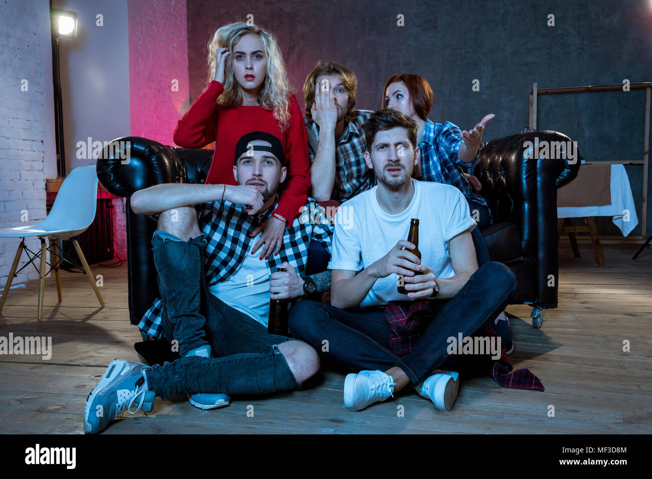 Group of friends watching TV match at home Stock Photo - Alamy
