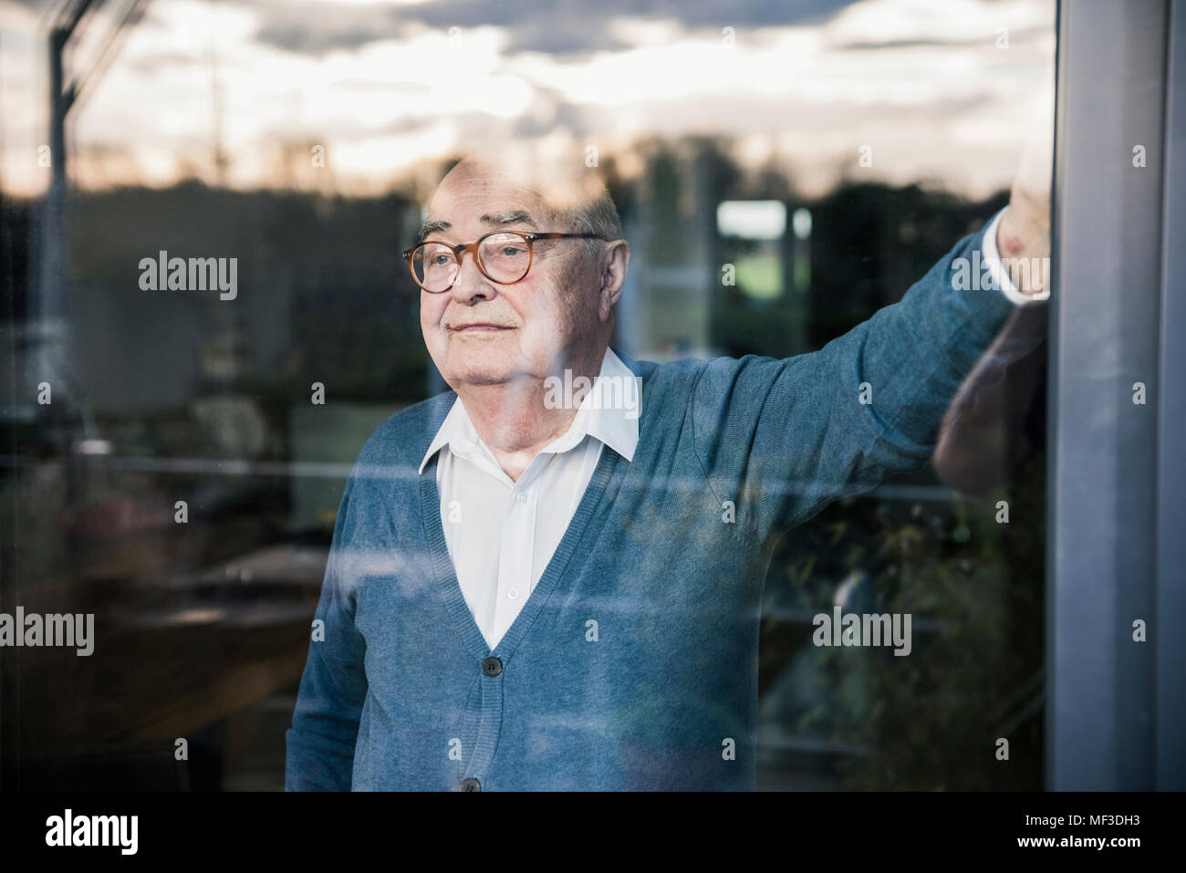 Portrait of serious man at the window looking out Stock Photo - Alamy