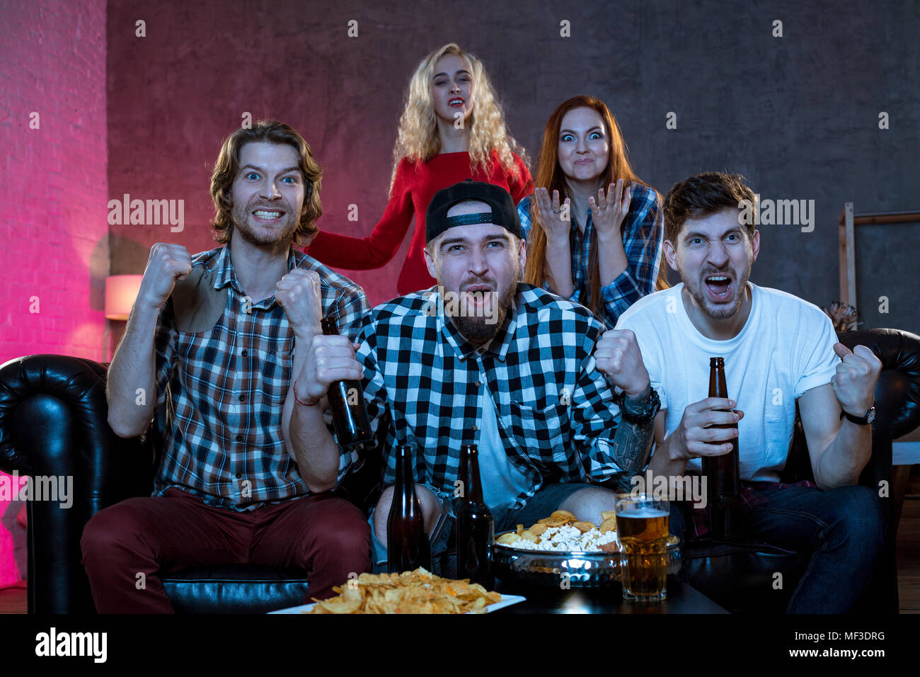 Group of friends watching TV match at home Stock Photo - Alamy