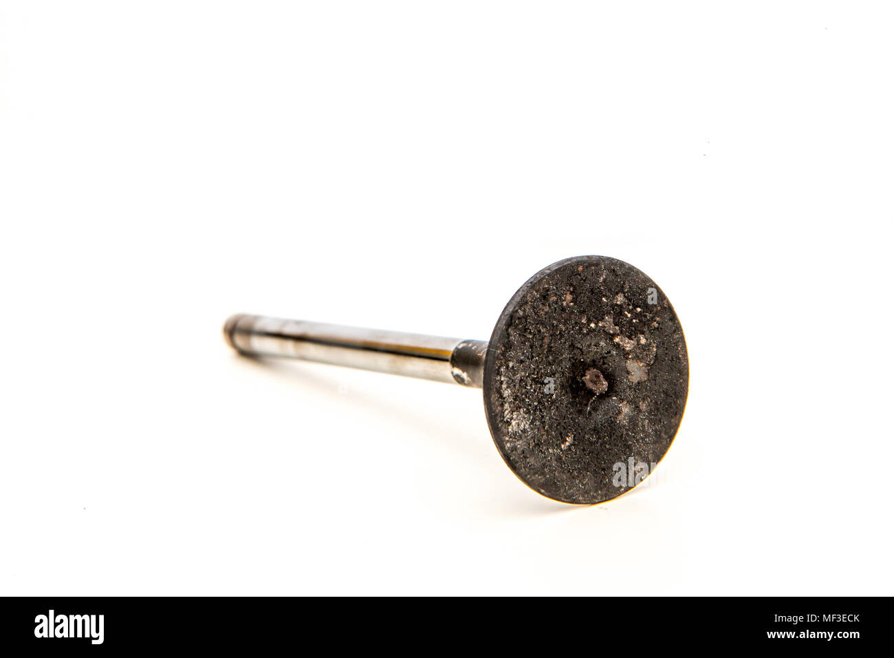 An used engine´s valve taken from the old engine. It is covered with ...