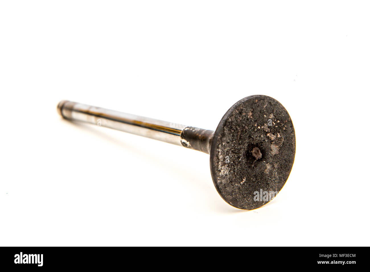 An used engine´s valve taken from the old engine. It is covered with ...