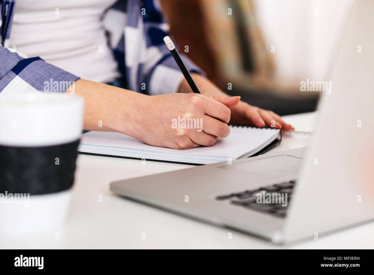 Close up woman writing at desk hi-res stock photography and images - Alamy