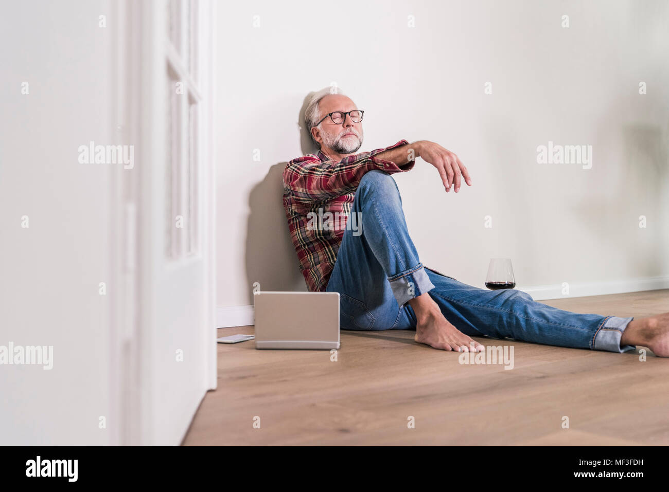 Barefoot man relaxing on the floor at home Stock Photo - Alamy