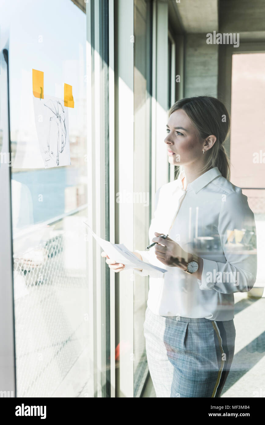 Young women standing papers hi-res stock photography and images - Alamy