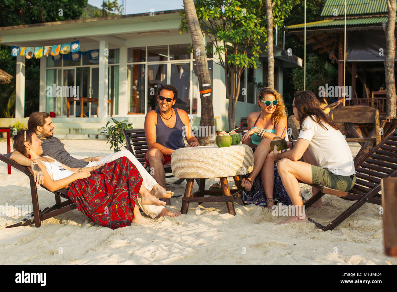 Thailand, Koh Phangan, friends having fun in a cafe at the beach Stock ...