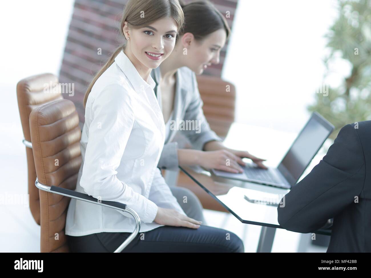 office workers sitting behind a Desk Stock Photo - Alamy