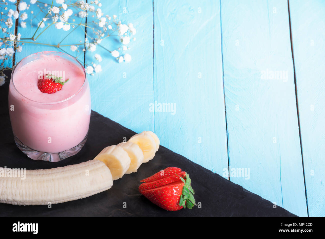 Healthy eating concept with a glass of fresh strawberry and banana ...