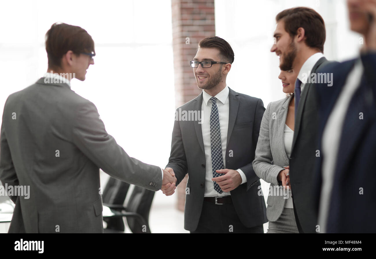 Confident young people, handshake and smile Stock Photo - Alamy