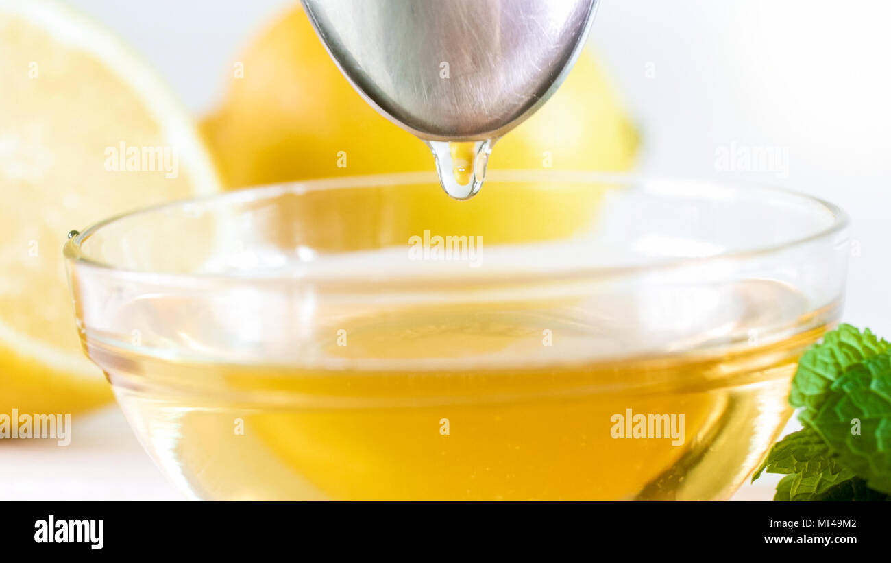 Macro image of bee honey dripping from metal poon Stock Photo - Alamy