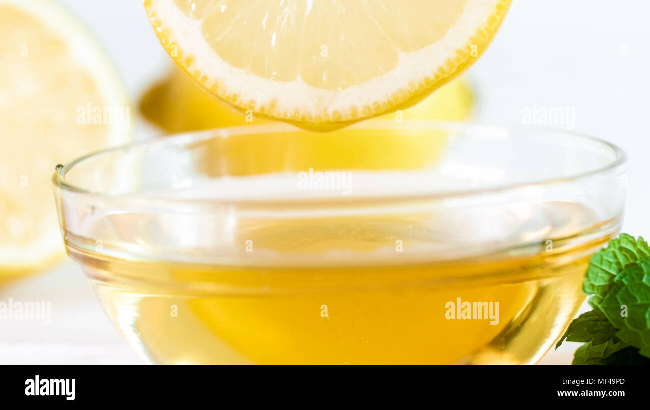 Macro image of bowl with honey and lemon slice Stock Photo - Alamy