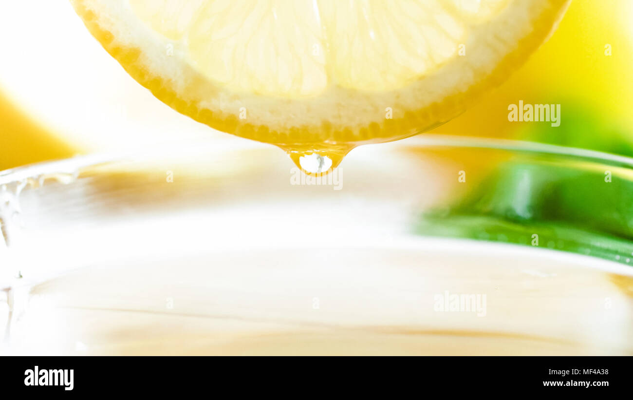 Macro image of lemon juice droplet falling in cup of tea Stock Photo ...