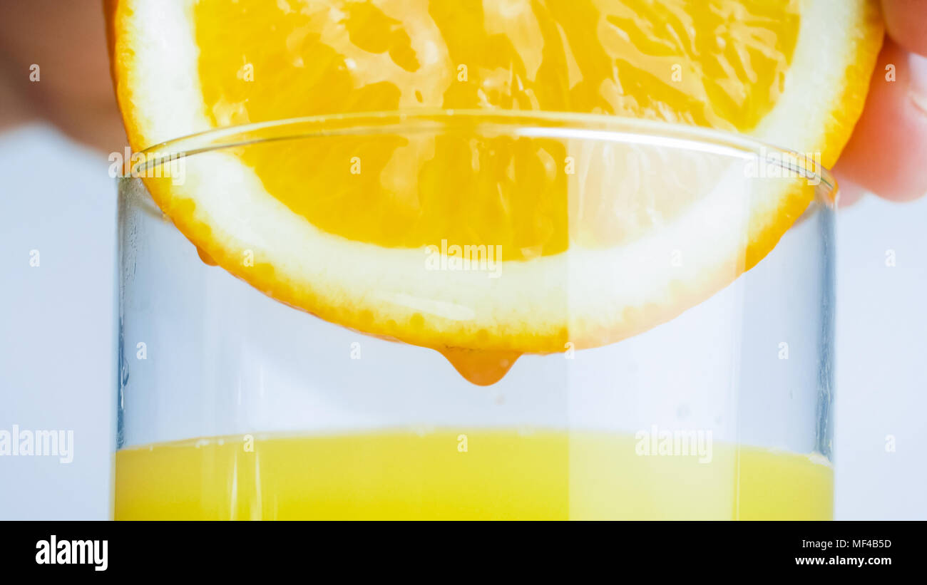 Hand squeezing half orange glass hi-res stock photography and images ...