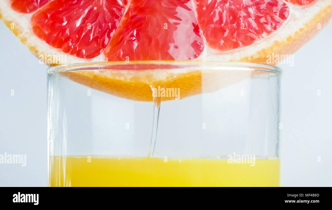 Macro image of juice flowing from fresh grapefruit in glass Stock Photo ...