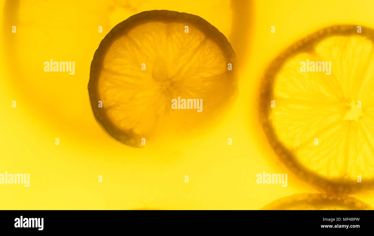 Closeup backlit image of orange slice floating in juice Stock Photo - Alamy