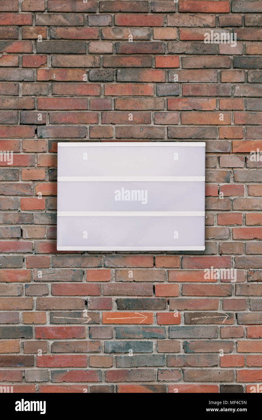 Brick wall background with copy space in empty light box as template ...