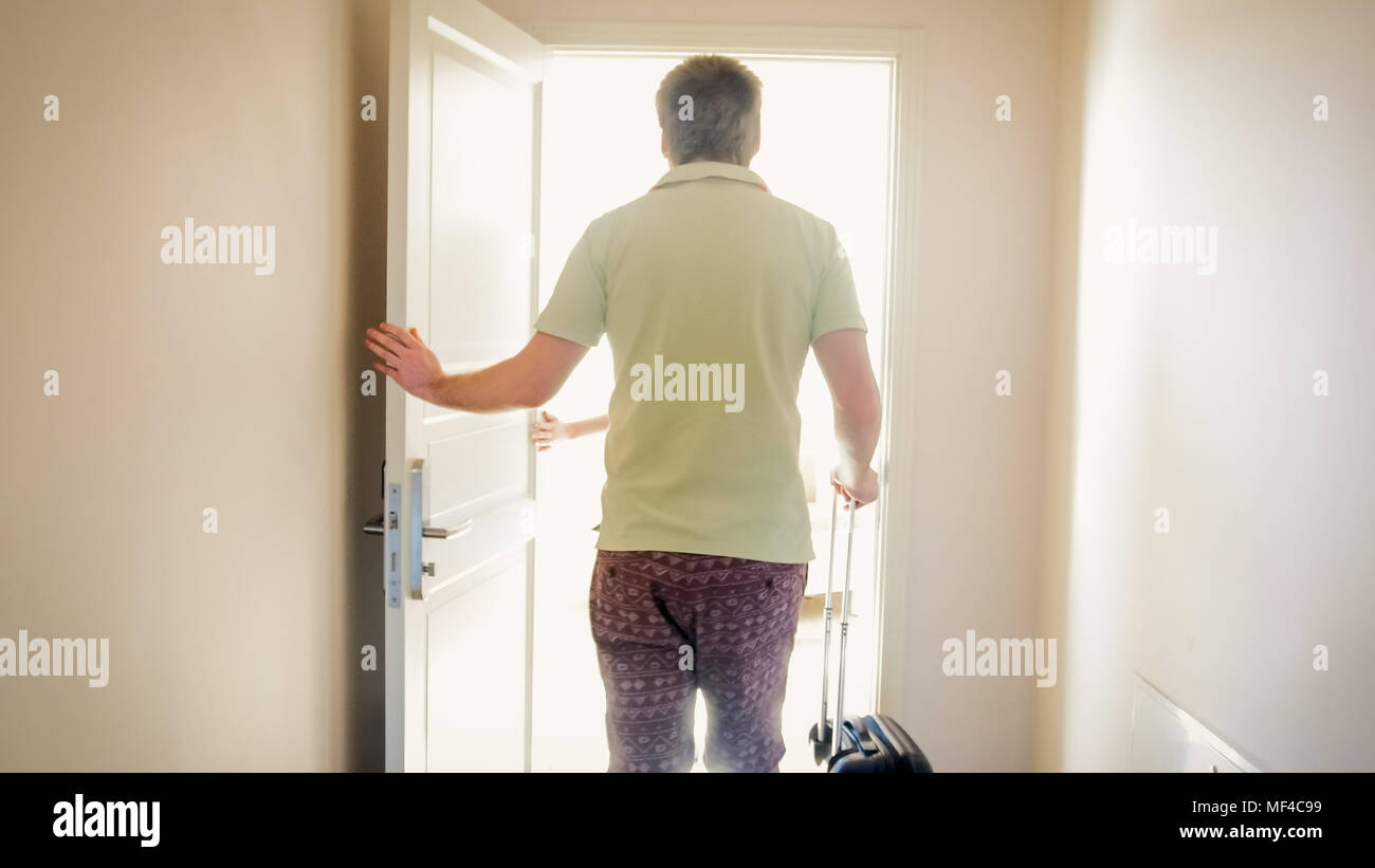 Young male enter hotel room hi-res stock photography and images - Alamy