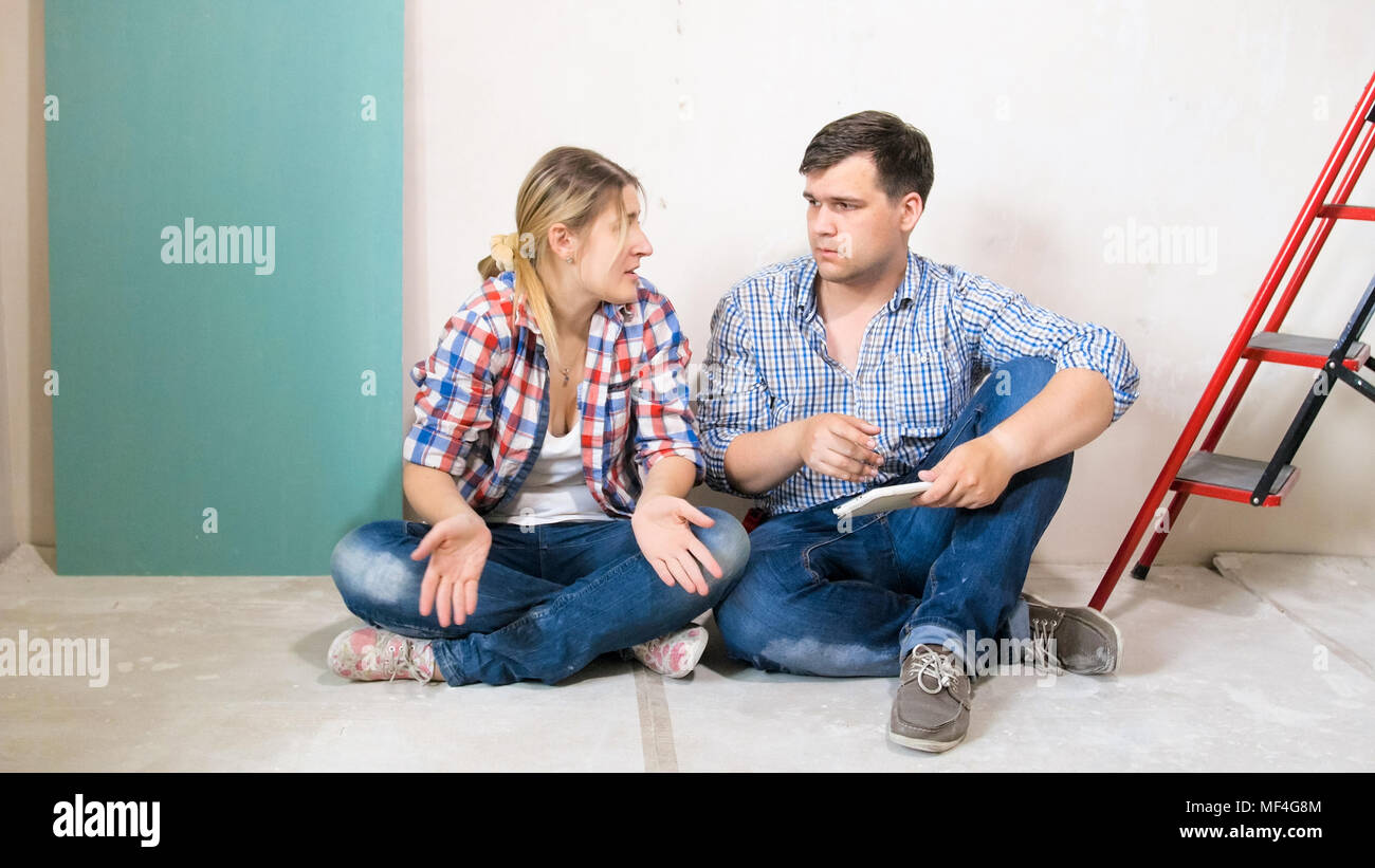 Young couple arguing in new house under renovation Stock Photo - Alamy