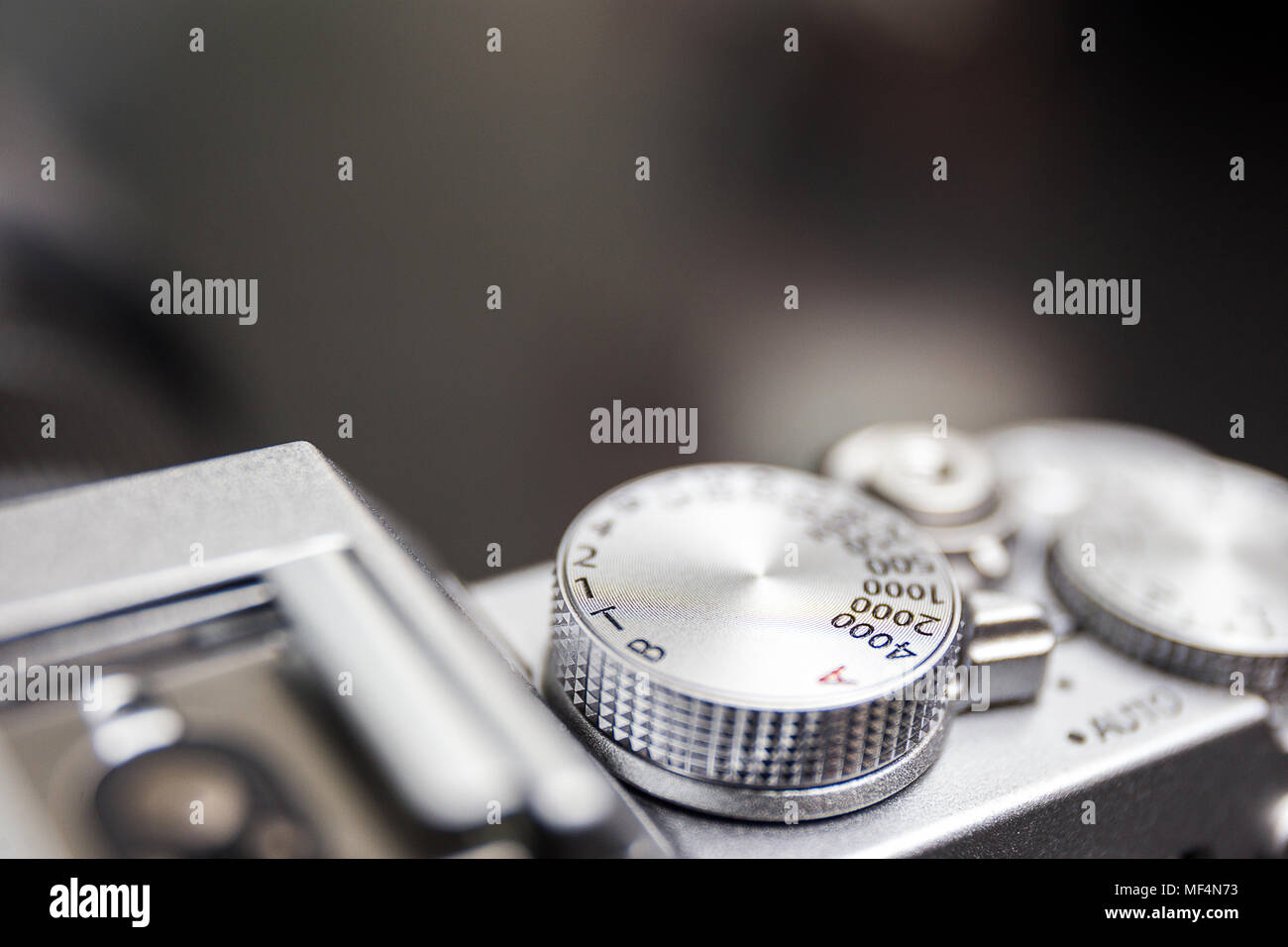shutter speed and exposure control dial, button, on silver modern mirrorless camera Stock Photo ...