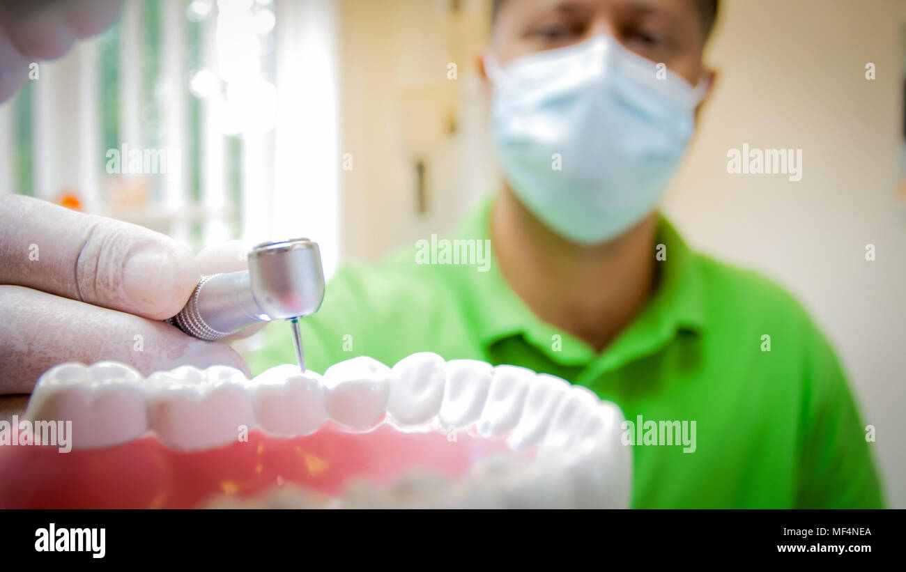 Closeup photo of male dentist using dental drill in teeth treatment ...