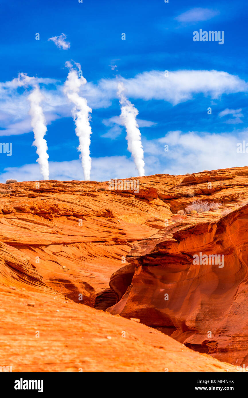 Smoke stacks visible from the Navajo Generating Station in the desert ...