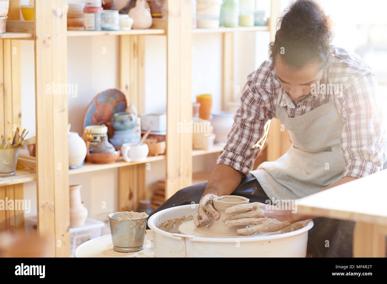 Young professional African American craftsman sitting in workshop and ...