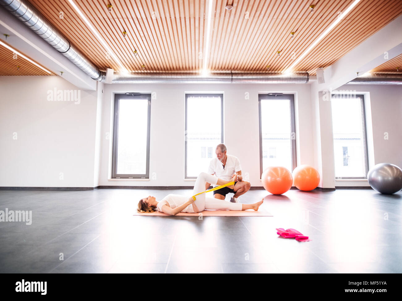 Female physiotherapist helping young hi-res stock photography and ...