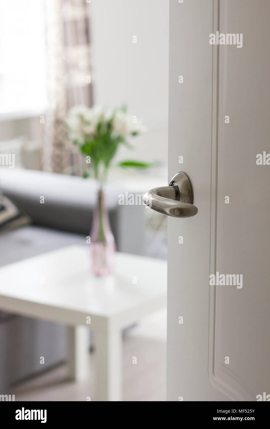 Open door to room with bouquet of flowers on table, Scandinavian ...