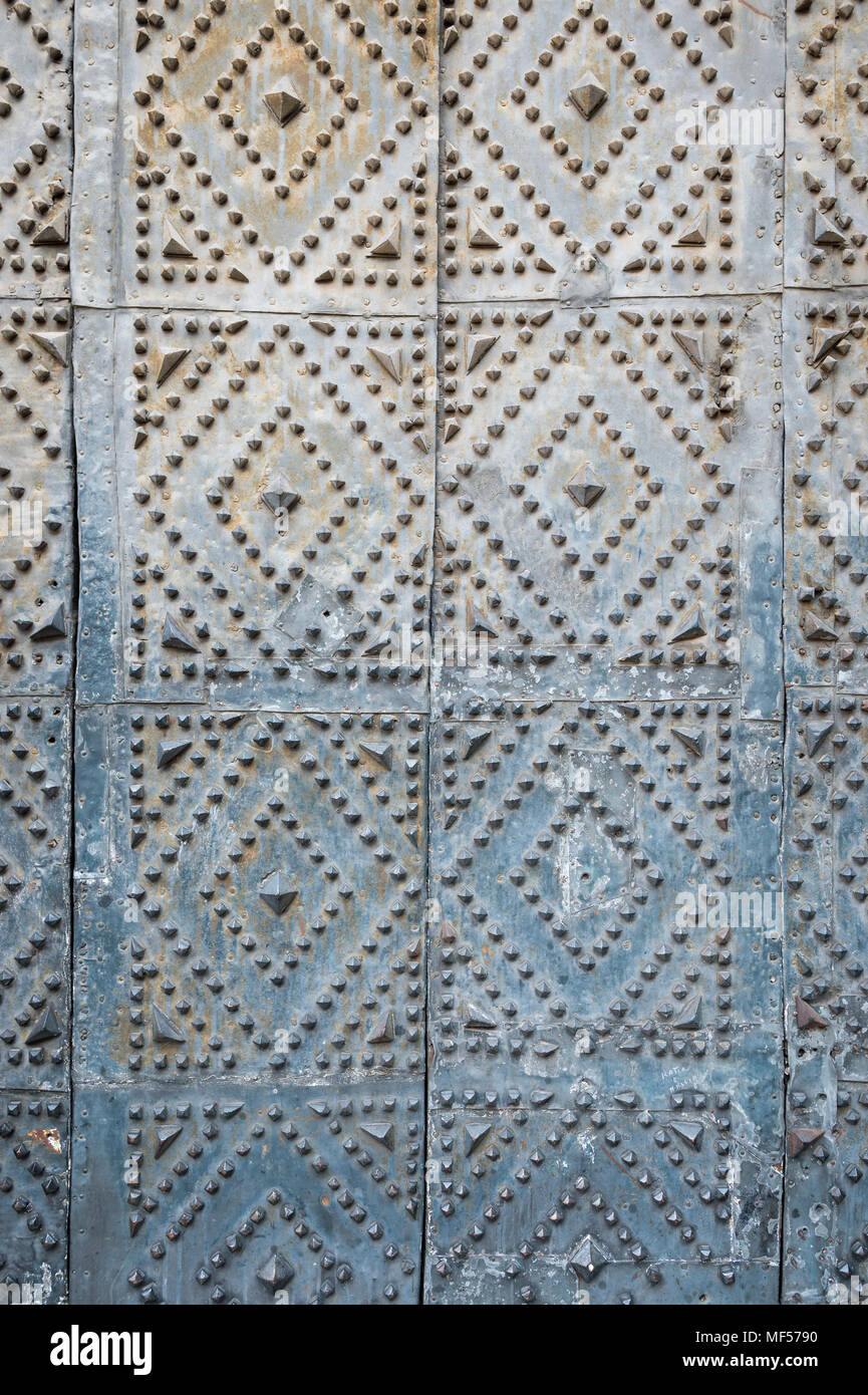 Abstract detail of medieval metal doors with studs in diamond pattern ...