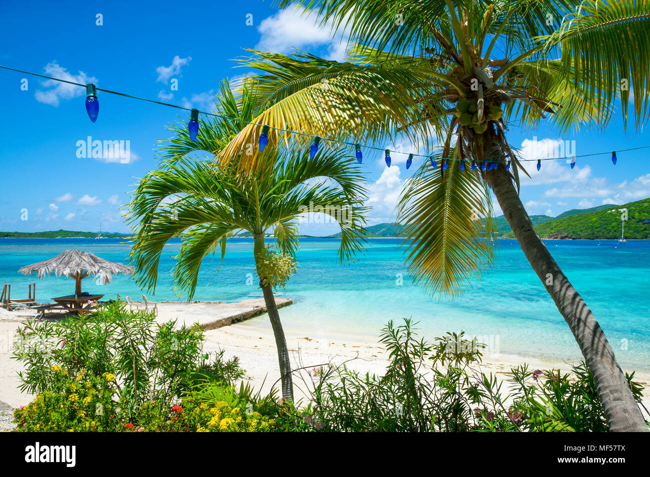Beautiful bright view through tropical vegetation to a white sandy ...