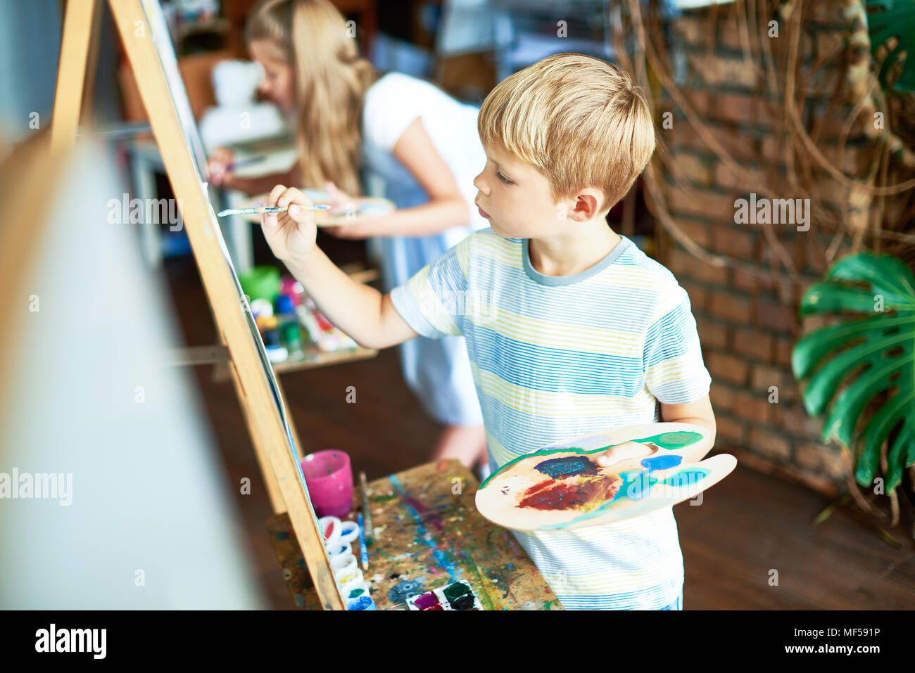 Cute Boy Painting in Art Class Stock Photo - Alamy