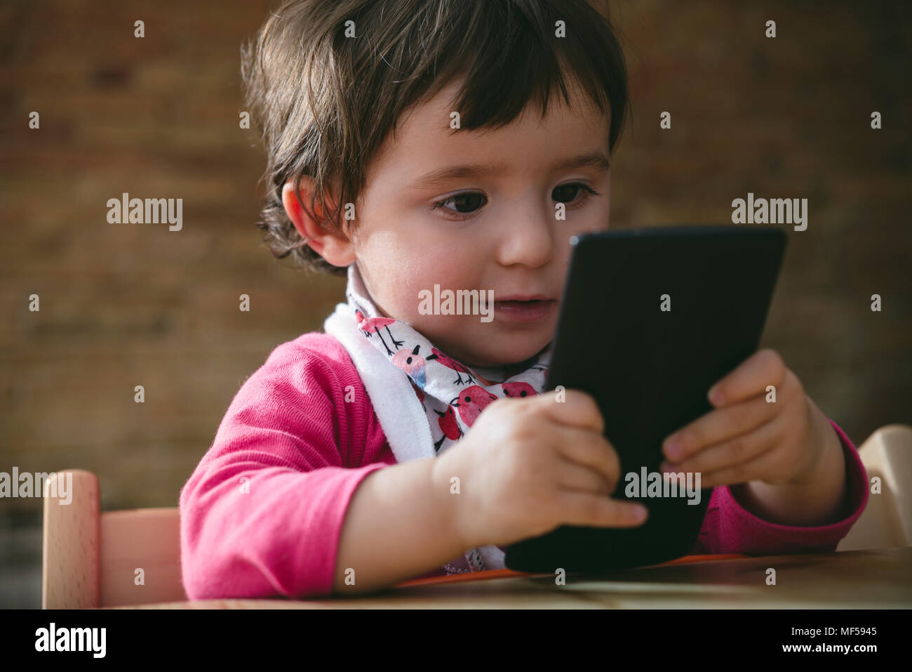 Baby watching phone hi-res stock photography and images - Alamy