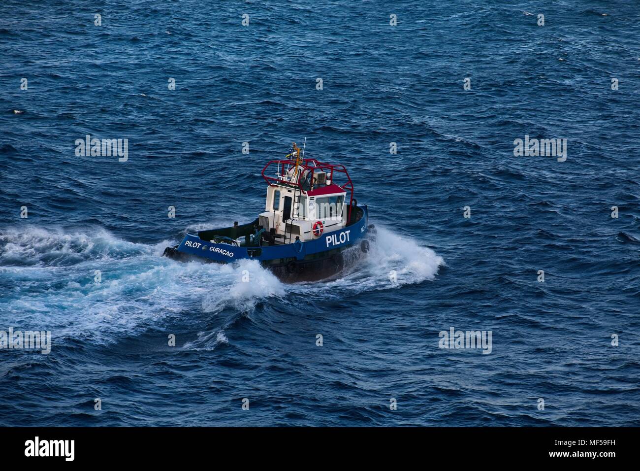 A pilot boat sailing into the harbor on Curacao Stock Photo - Alamy